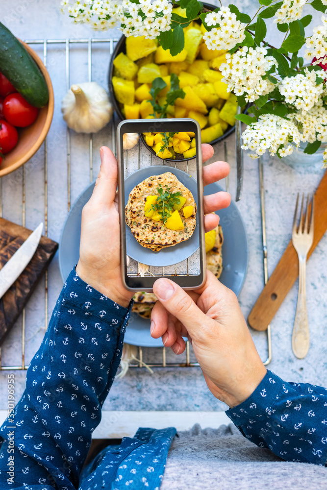 Make picture of vegan food with phone. Smartphone blogging photography ...