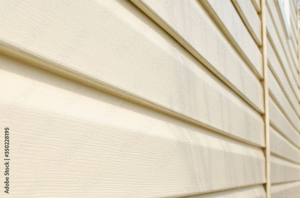 Light beige vinyl siding of the house. Plastic panels texture. Stock ...