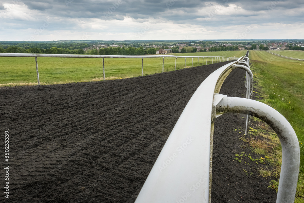 Deep depth of field of white track barriers seen extending to the far ...
