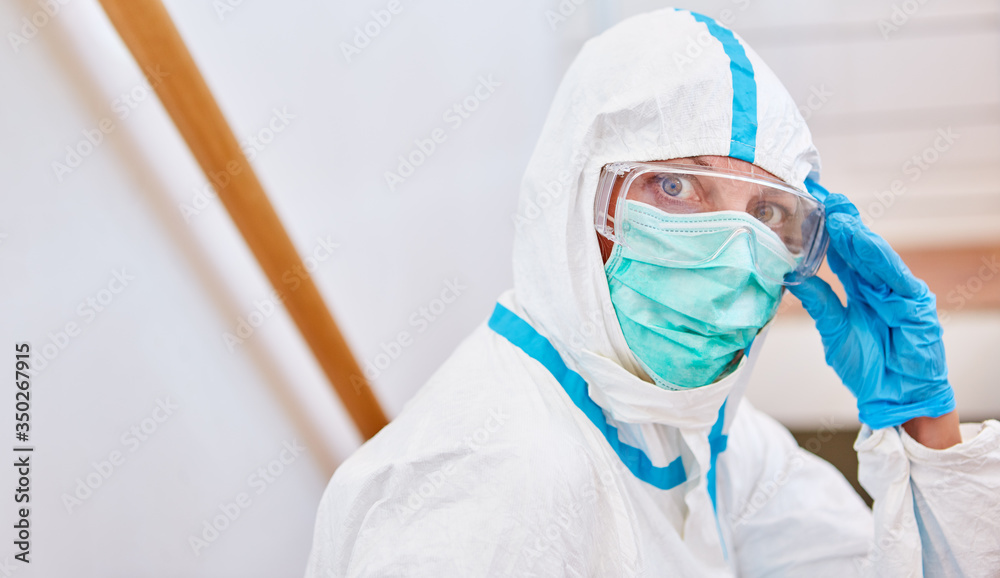 Doctor in protective clothing takes a break because of coronavirus ...