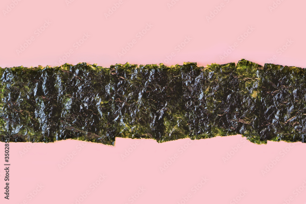Crispy seaweed on the pink background with copy space. Japanese or ...