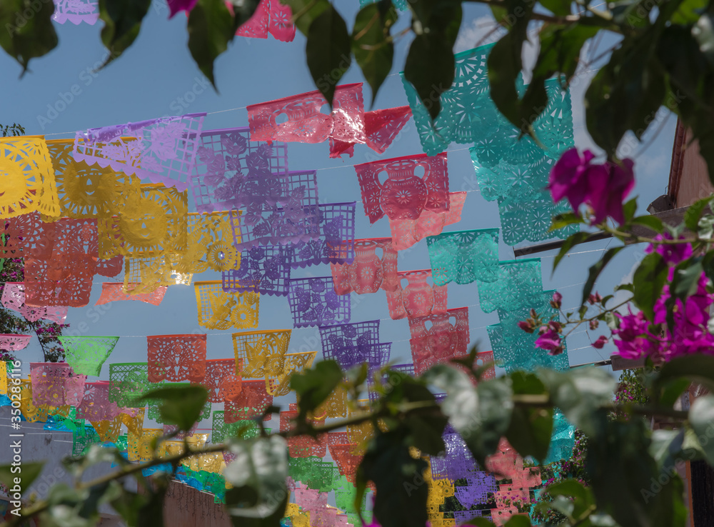 "Papel picado" is a decorative craft made by cutting elaborate designs ...