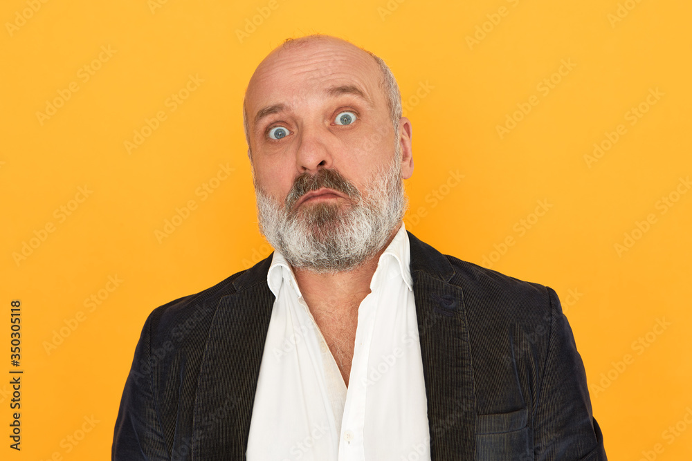 Portrait of bug eyed unshaven elderly male with expressive mimics ...