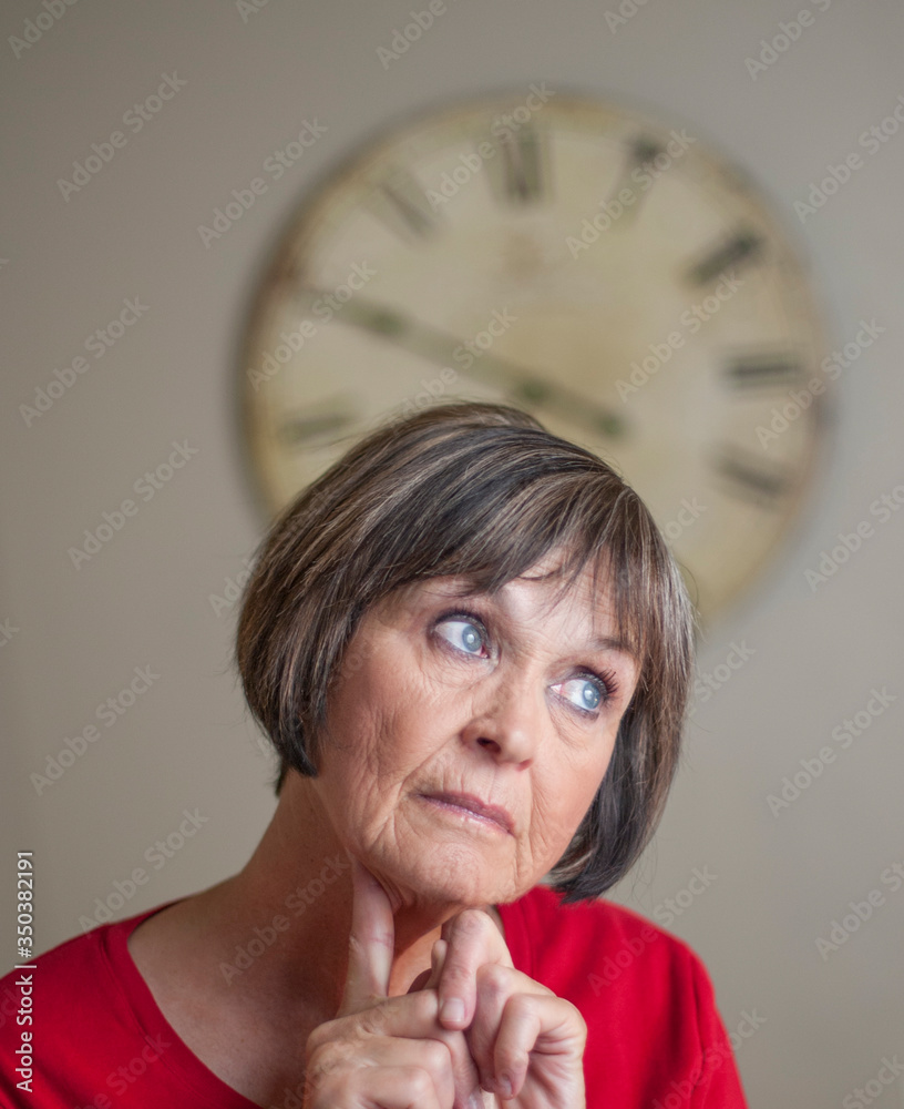 Woman reacts with doubt and unsureness as she contemplates time on the ...