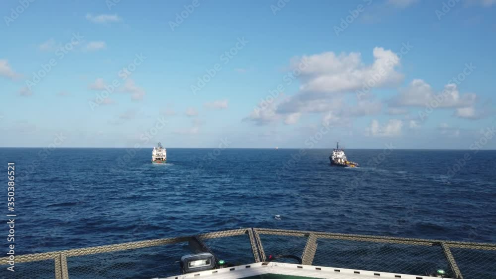 Offshore supply vessel tow a jack up oil drilling rig in the middle of ...