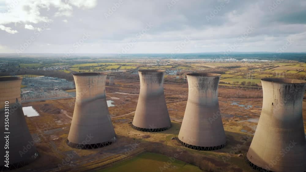 An aerial view of five abandoned cooling towers from an old fossil fuel ...