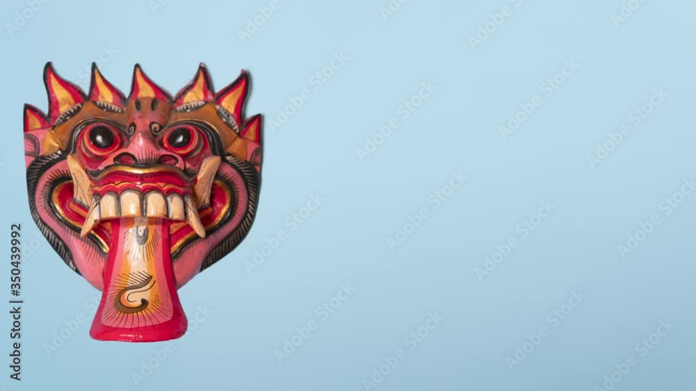 4K stop motion video of a wooden Balinese Barong Mask with blue ...