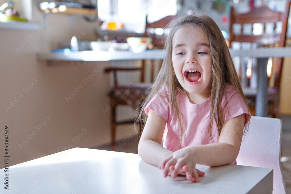 little girl with their mouths wide open. The child are playing. the ...