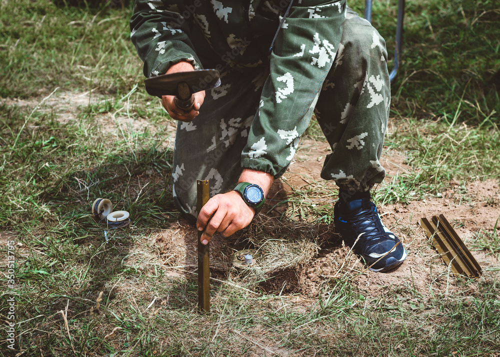 Minesweeper is preparing for a mine detonator. Soldier sets anti-tank ...