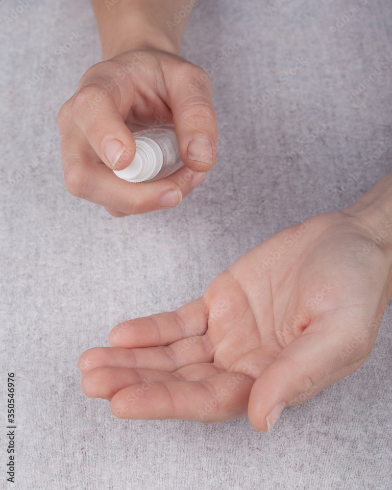 apply antiseptic spray, disinfection of hands close-up, white ...