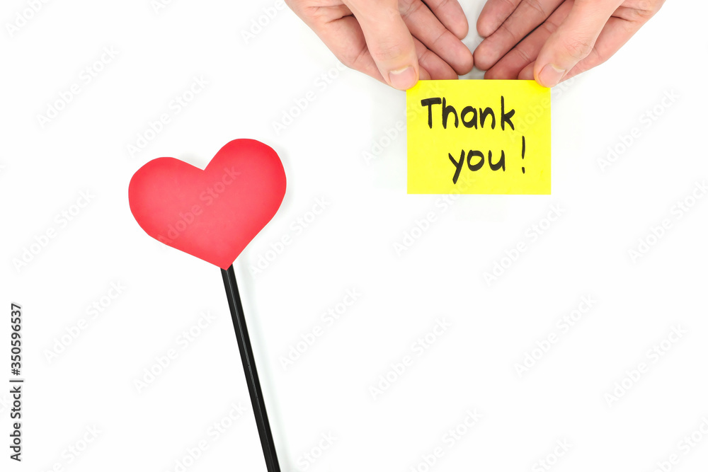 Human hands holding a bright yellow thank you card note. Showing ...