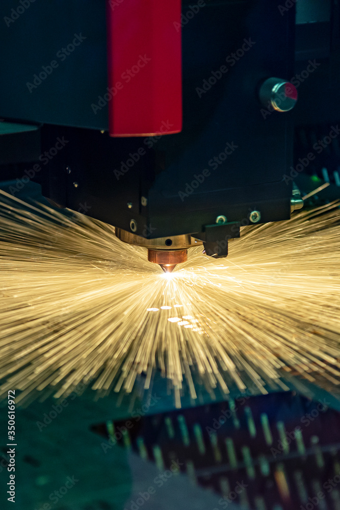 The vertical scene of fiber laser cutting machine cutting the sheet ...