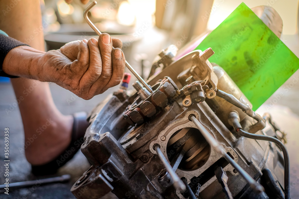 Repair mechanic using engine disassembly tools Stock Photo | Adobe Stock