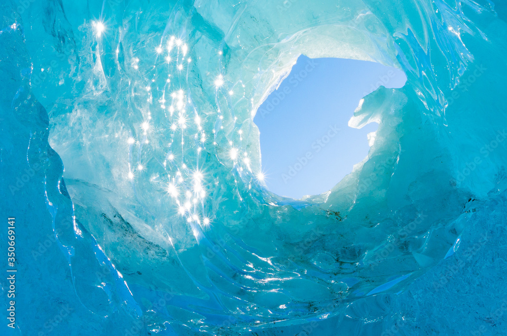 The view through an iceberg with beautiful shades of blue and star ...