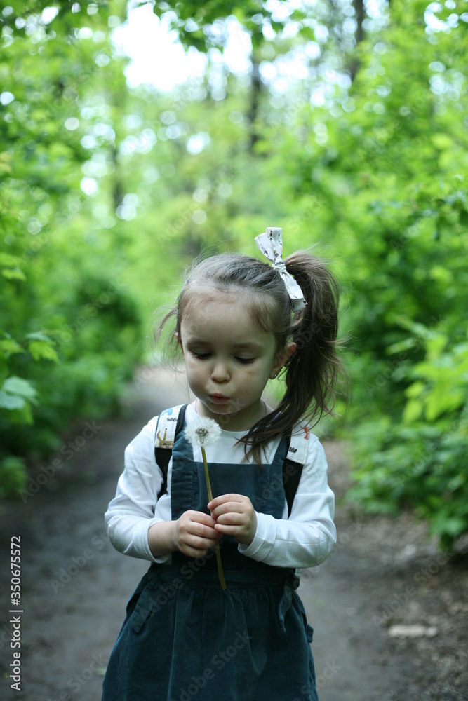 Child alone in the forest.Happy child. Happy little girl. A child in ...