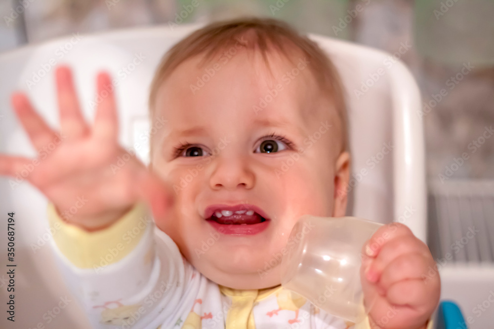 Baby in a high chair. A cranky toddler. Discontent. The emotions of a ...