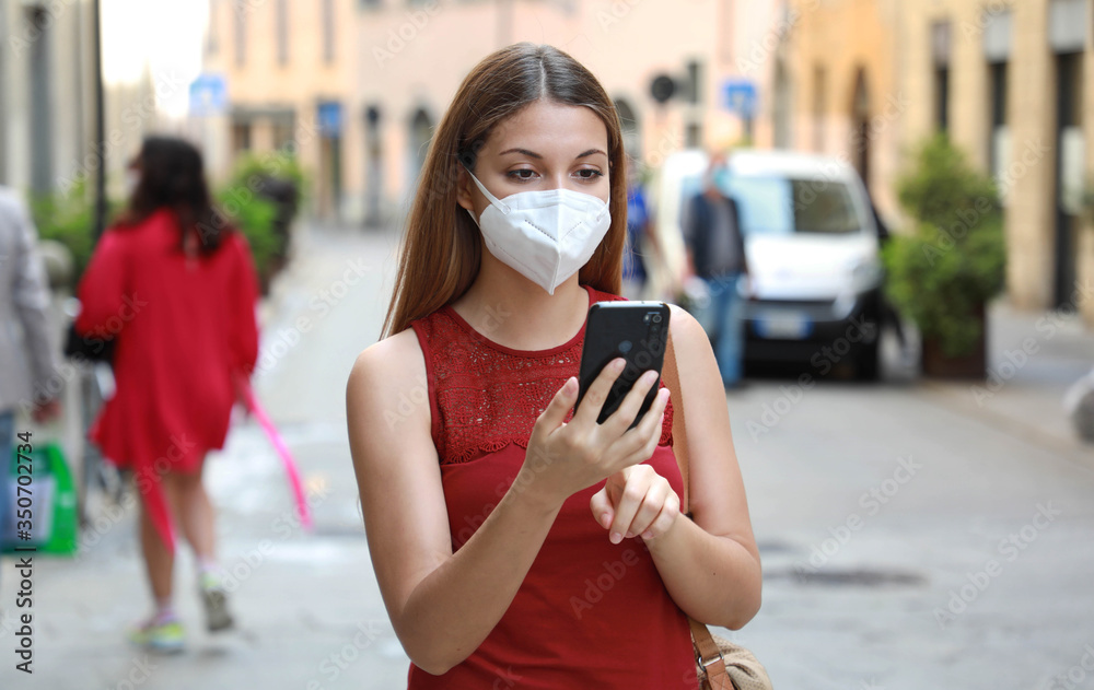 COVID-19 Woman in city street wearing KN95 FFP2 mask against disease ...