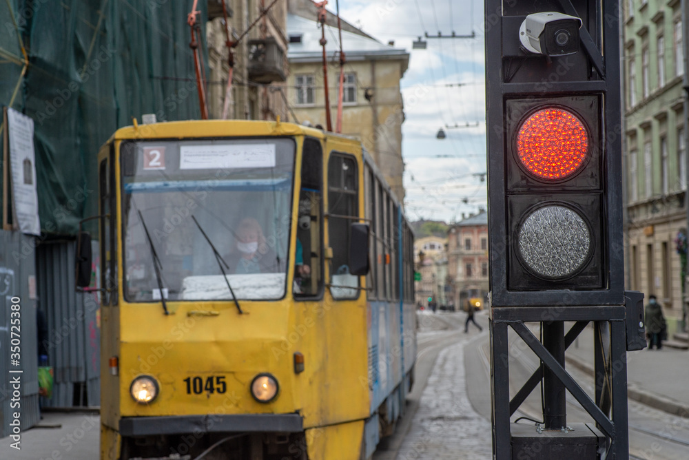 Traffic light with old yellow tramway in the background. Stock Photo ...