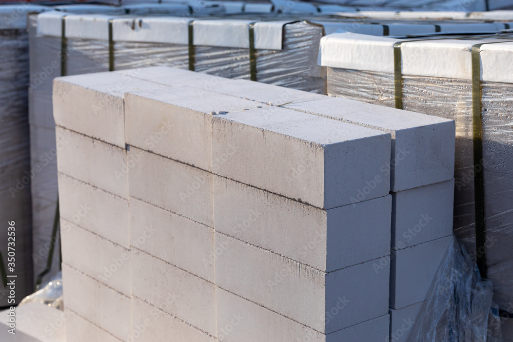 Silicate brick on wooden pallets wrapped in transparent plastic wrap at ...