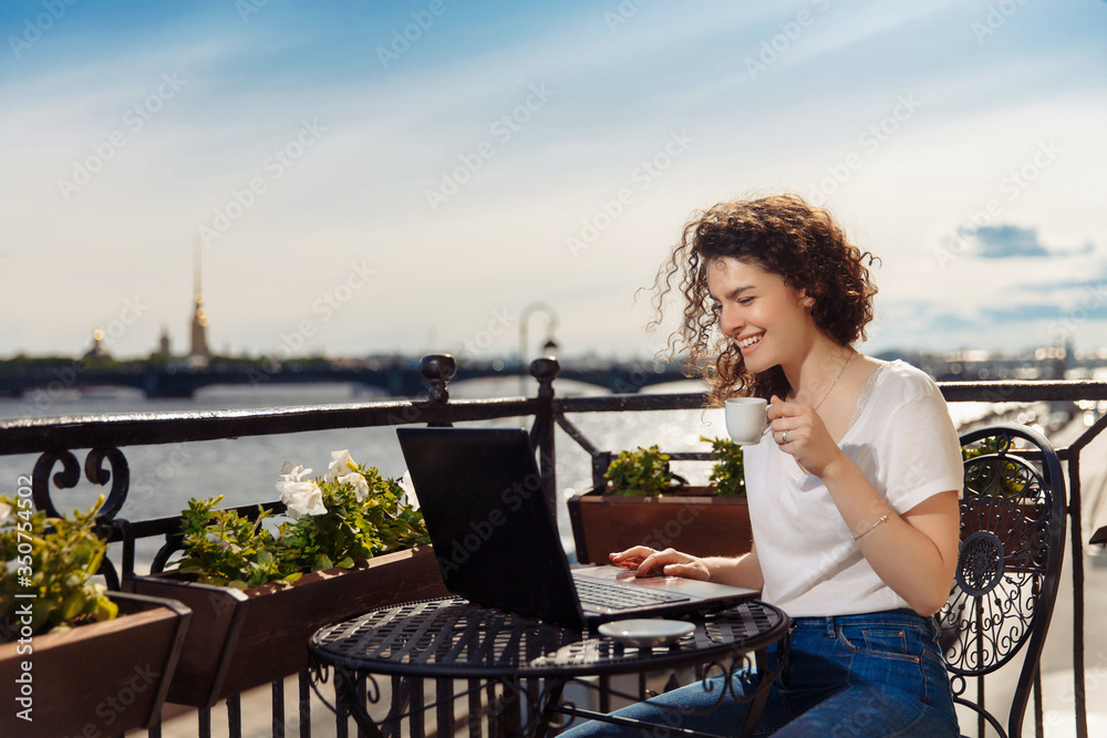 Cute happy young girl working on computer and smiling. Beautiful woman ...