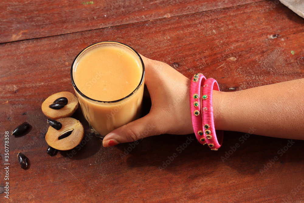 Ripe fresh whole and half of sapota fruit isolated on white background ...