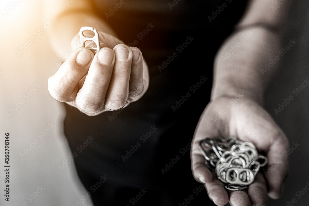 Hand holding stack of ring pull aluminum of cap cans.Raw materials for ...