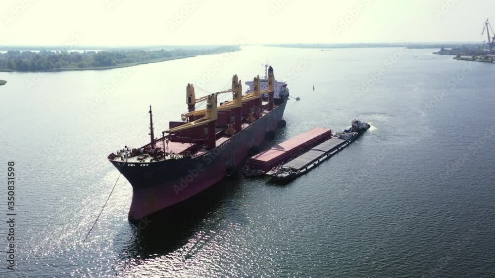 Slow tracking aerial of cargo bulker during underway ship to ship ...