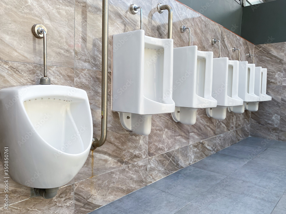 Men's white urinals design, Close up row of outdoor urinals men public ...