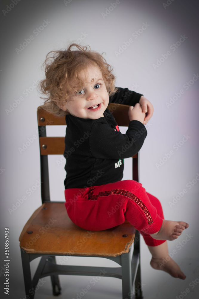 Cute Baby Boy Sitting On Chair Against White Background Stock Photo ...