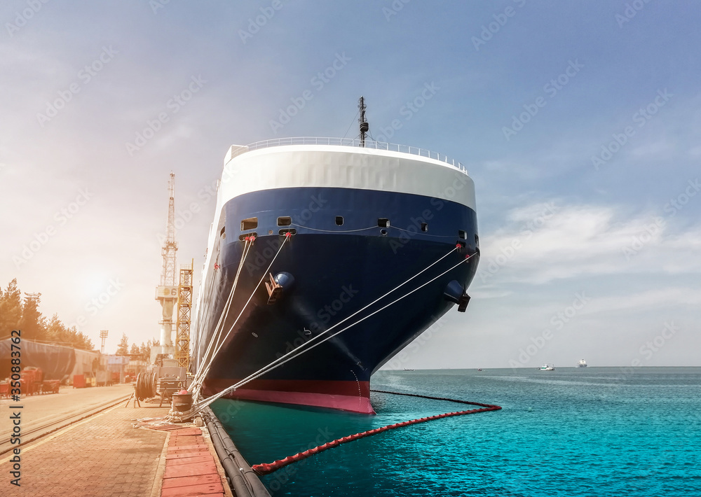Carrier ship front view a moored in the sea at quay wall alongside ...