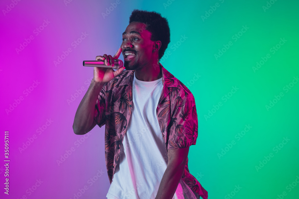 African-american male singer portrait isolated on gradient studio ...