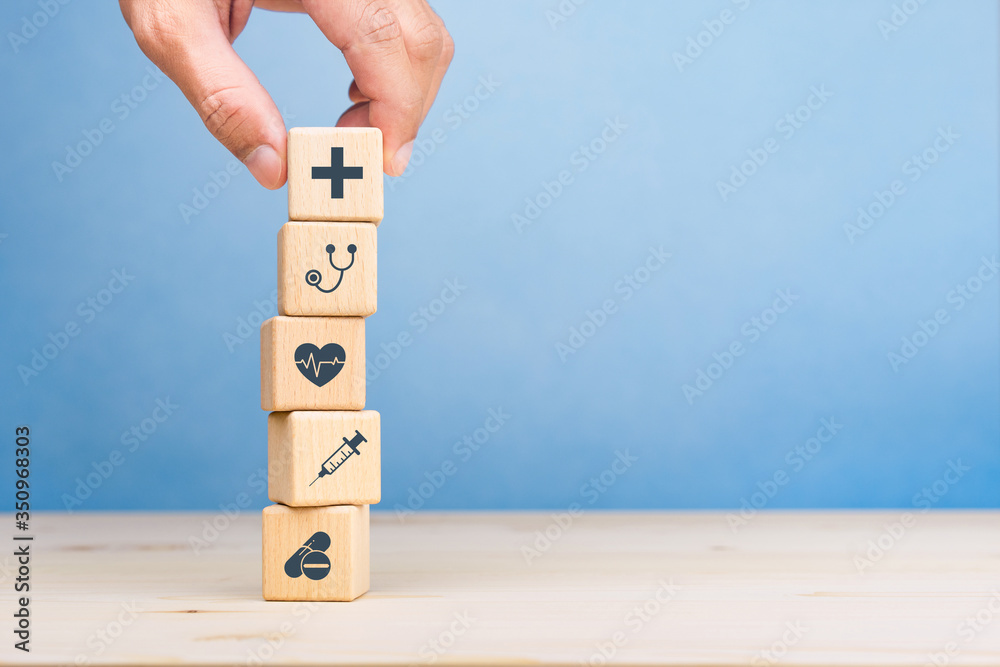 Health insurance concept, Hand holding wooden blocks with healthcare ...