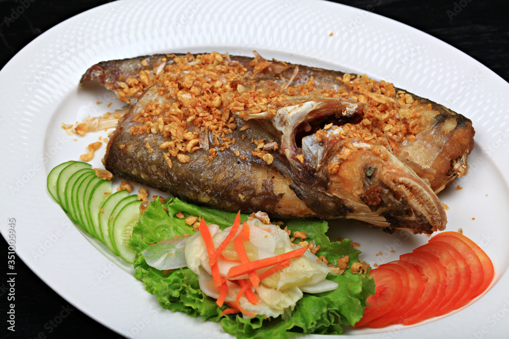 Ompok bimaculatus Fish Fried with crispy garlic Stock Photo | Adobe Stock