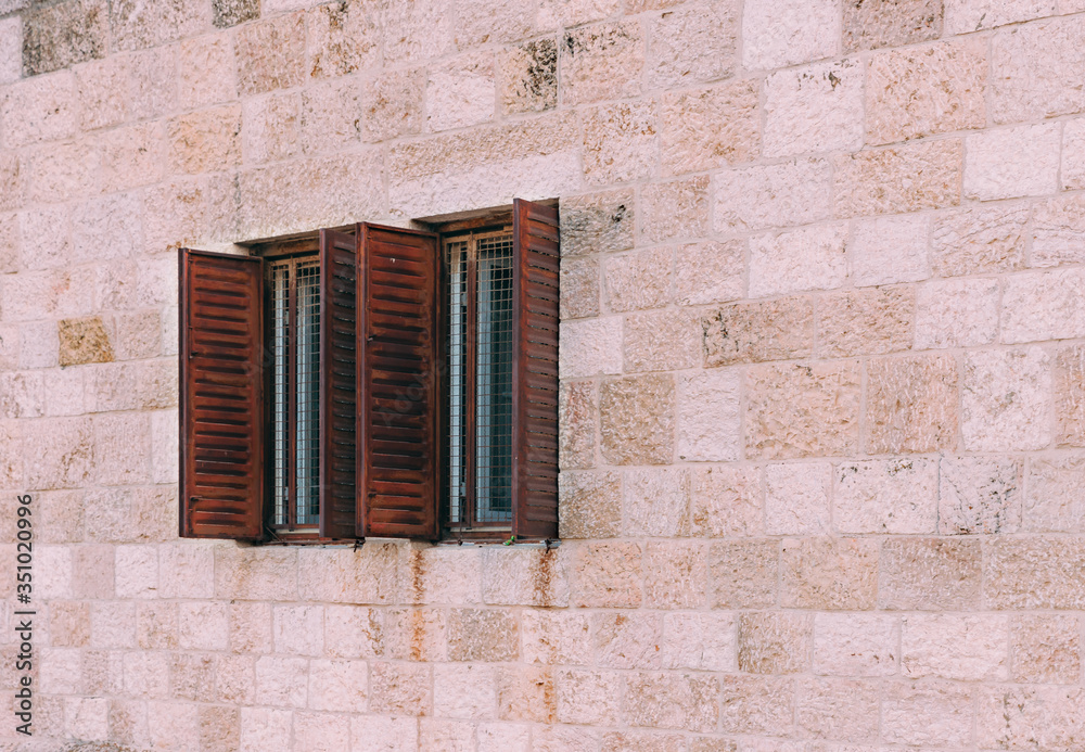 Old wall from the Jerusalem stone and window with lattice. Jerusalem ...