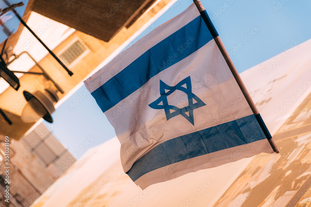 Israeli flag developing in the streets of Jerusalem. Blue and white ...