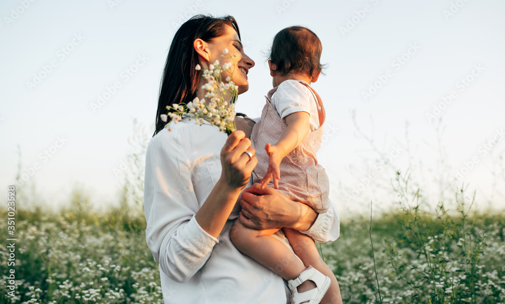 Image of gorgeous mother and cute little girl embrace each other with a ...