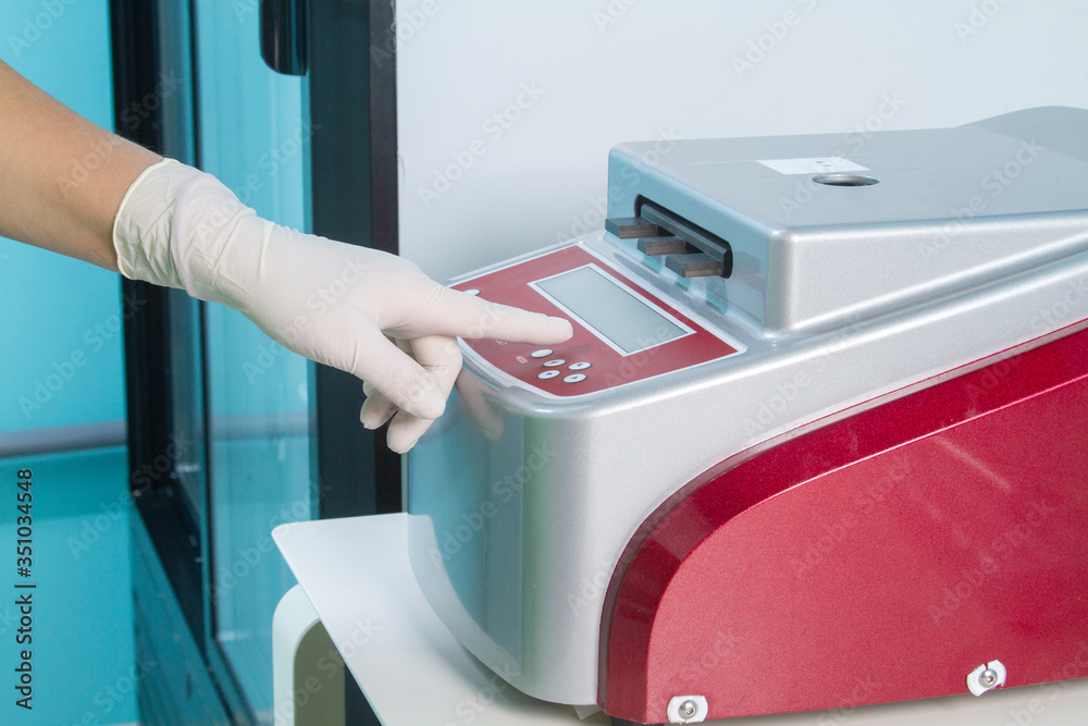 Histology test lab in hospital. Hands in gloves, tech loads slide ...