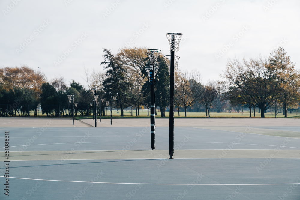 Netball goal ring and net against a blue sky and clouds at Hagley park ...