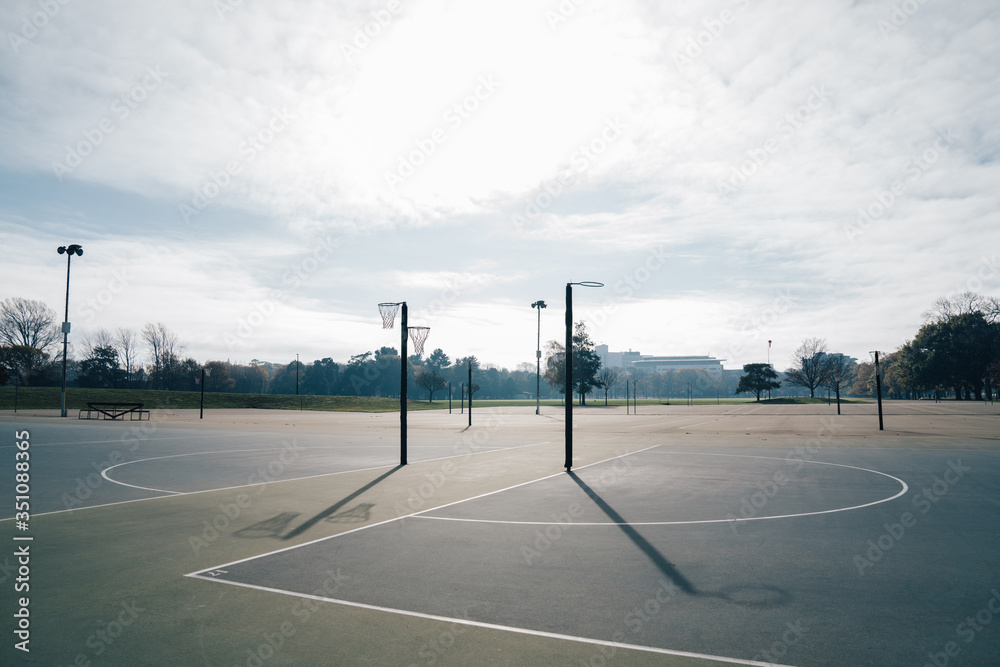Netball goal ring and net against a blue sky and clouds at Hagley park ...