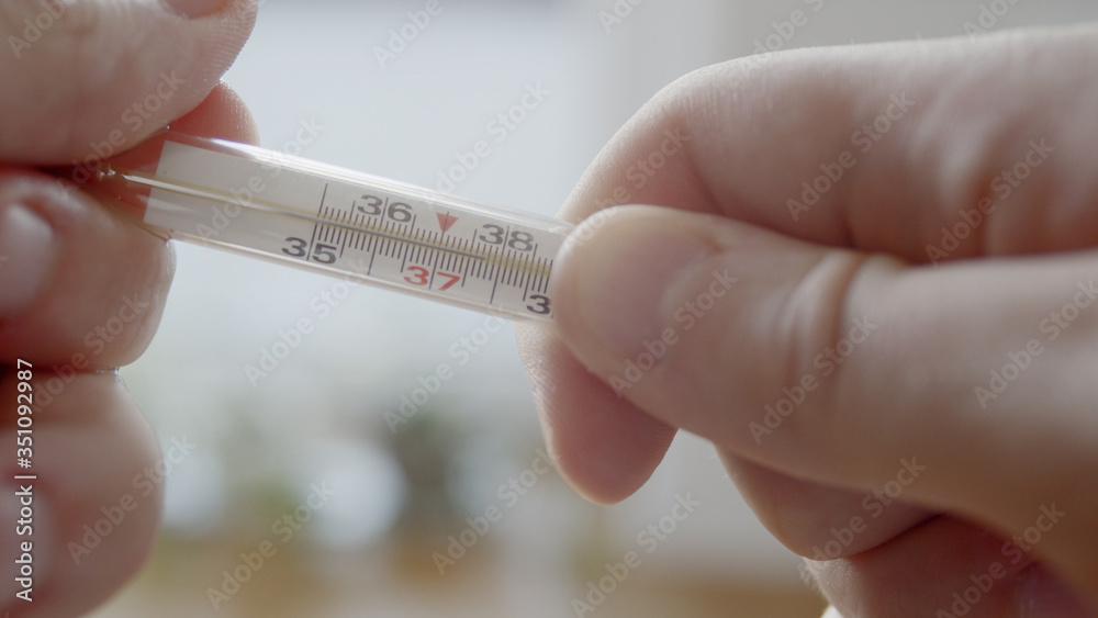 Taking temperature. Ricin rising in glass thermometer from normal to ...