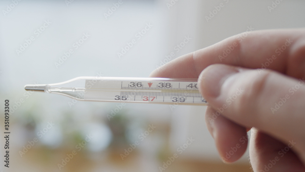 Foto de Taking temperature. Ricin rising in glass thermometer from ...