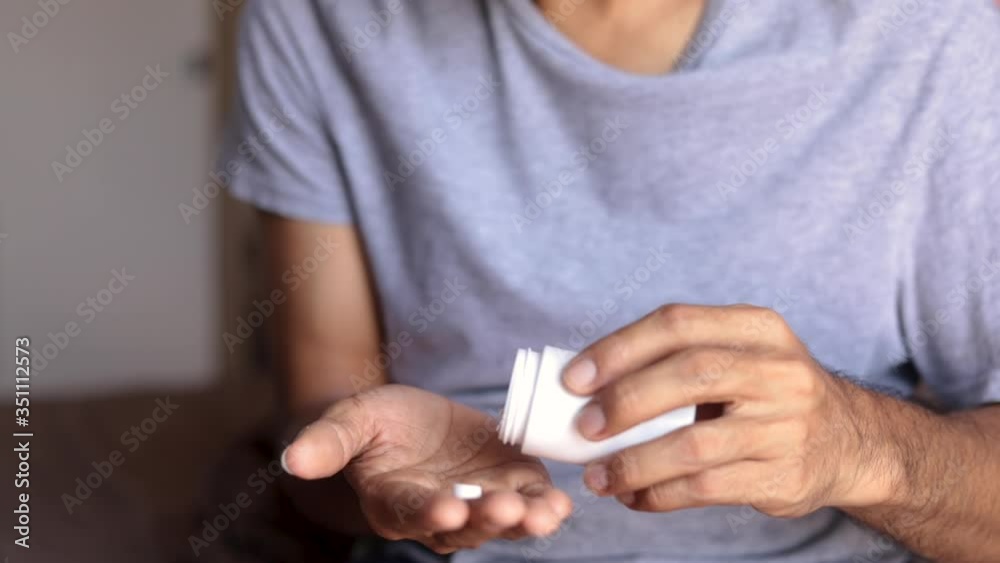 Male patients shiver hand while pouring medication into their hands ...