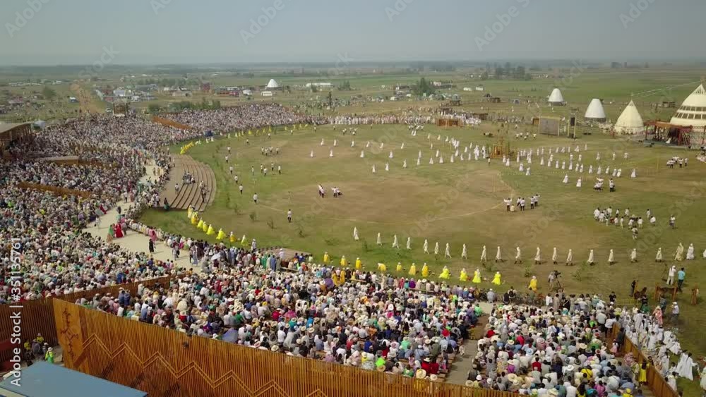 Aerial around grand stage scene yurts ethnic festival Yakutia ...