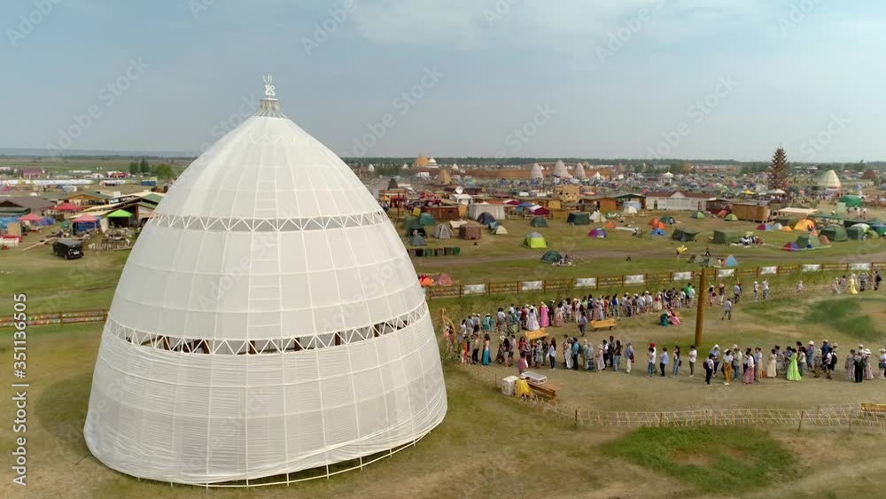 Flight around grand tall yurt Yakutia. Celebration village buildings ...