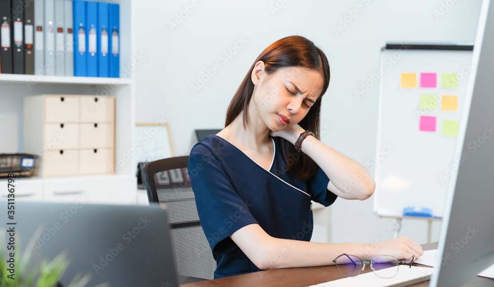 Asian business woman have a neck pain because using the laptop computer ...