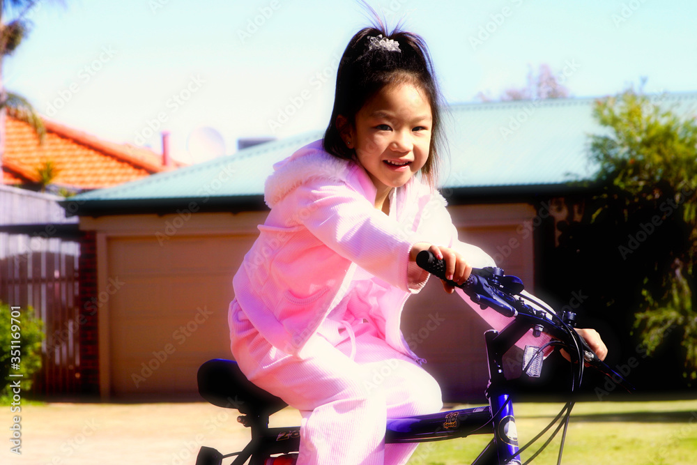 Young girl cycling during her free time Stock Photo | Adobe Stock