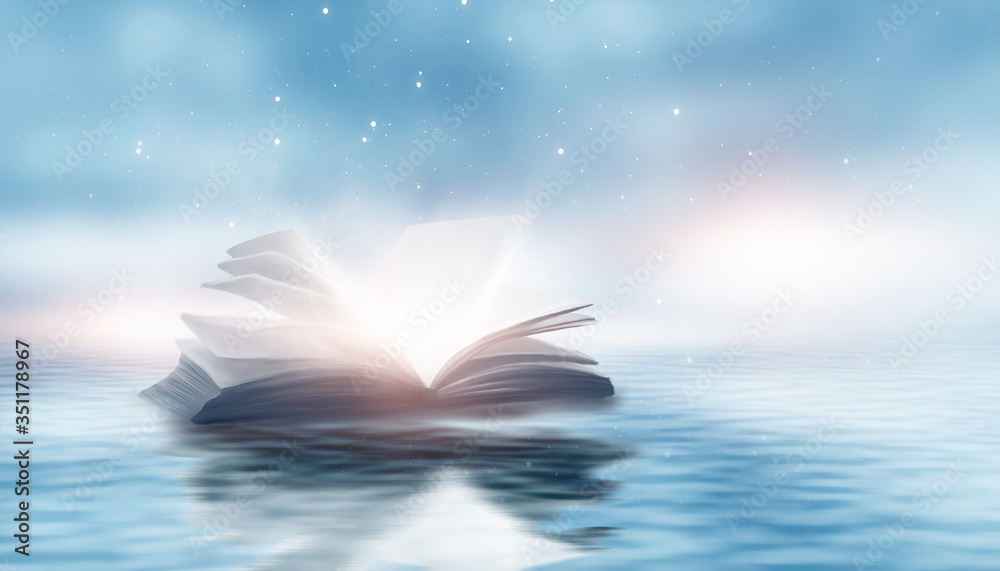 Open book on the water. Reflection of a book in the water. Sunlight ...