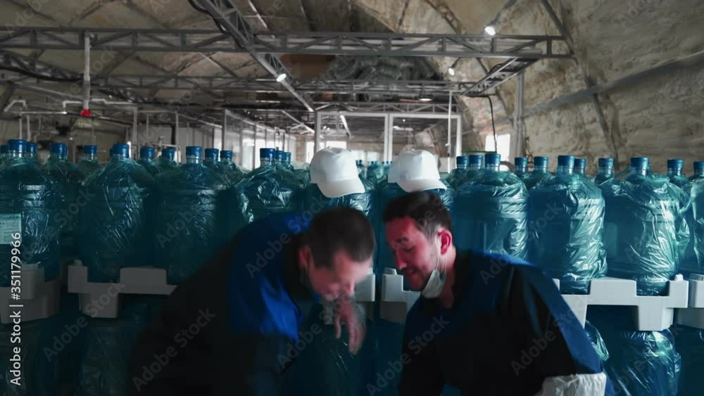 Pure water plant. Two employees on vacation drink clean water on the ...