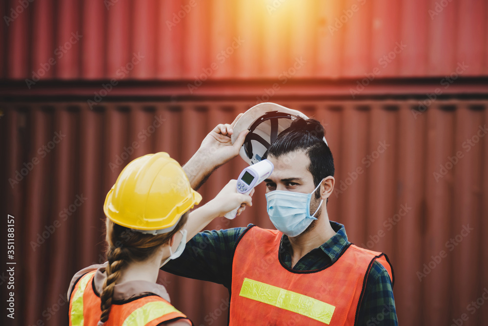 industrial worker woman temperature checking fever by digital ...