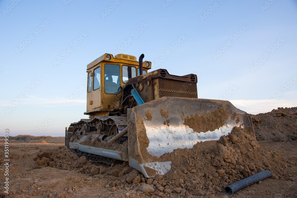 Dozer at open pit mining on sunseet background. Bulldozer for land ...